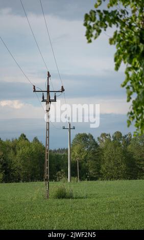Old electric poles with stretched cables. Old electrical network ...