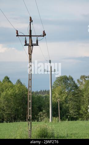 Old electric poles with stretched cables. Old electrical network ...