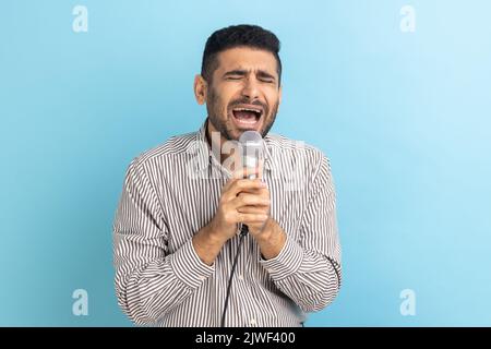 Portrait of a happy businessman singing on microphone Stock Photo - Alamy