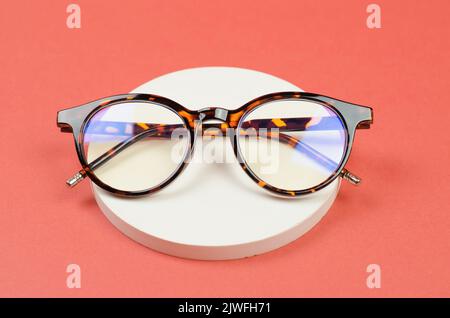 Stylish eyeglasses on a round podium. Leopard glasses Stock Photo - Alamy