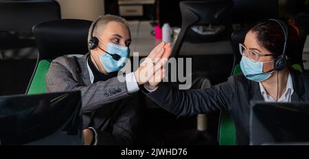 Covid, high five and women in call center with face mask for office ...