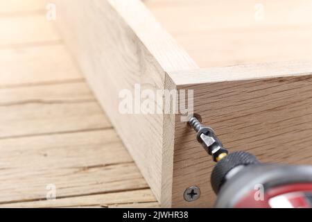 Driving screws into a wooden frame with an impact drill Stock Photo - Alamy