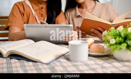 Young students doing assignment on laptop together Stock Photo - Alamy