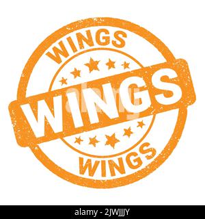 WINGS text written on orange grungy stamp sign Stock Photo - Alamy