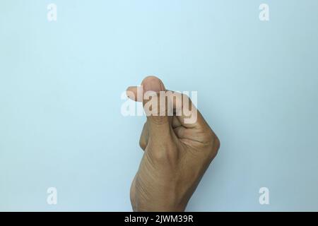 A hand signs gesture to be little heart from tip of thumb and index ...