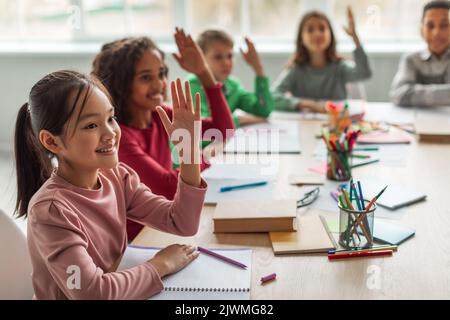Multiethnic School Kids Learning Raising Arms During Lesson In ...