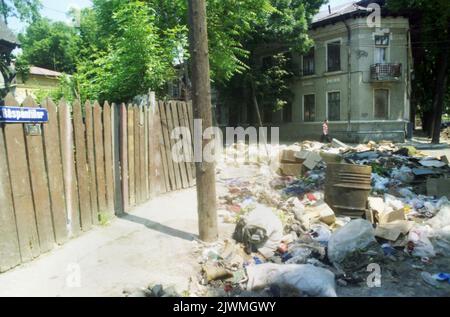 Bucharest, Romania, cca 1992. Piles of trash on a neighborhood street ...