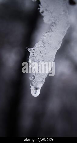 Melting snow dripping water from top of bright red metal wall Stock ...