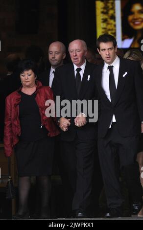 The father of Jill Meagher, George McKeon (right) hugs her husband Tom ...