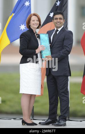 Prime Minister Julia Gillard presents actor Geoffrey Rush with his 2012 ...