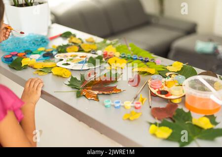 Notepad with watercolor paintings autumn leaves. View of workplace ...