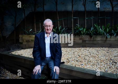 Australian author Denis Ryan poses for photographs in Sydney, Wednesday ...