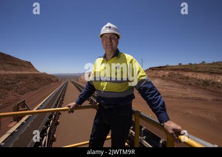 FMG CEO Nev Power stands on an embankment at Kings Ore Processing ...