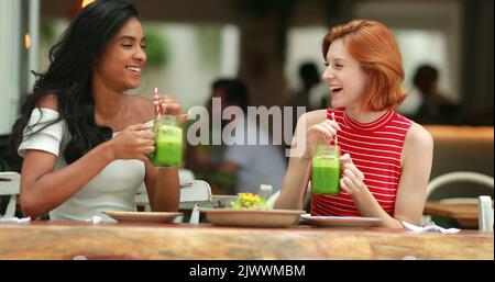 Multiracial girl drinking healthy green juice outdoors Stock Photo - Alamy