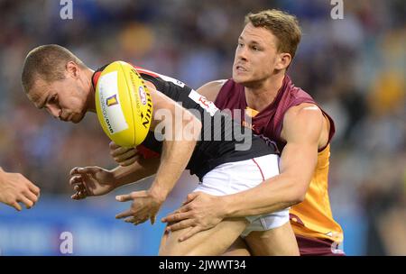 Lions player Jack Redden is tackled by Cats player Steve Johnson in the ...