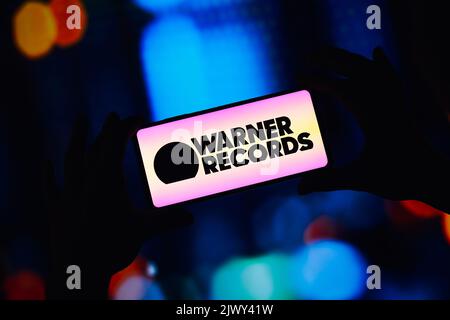 In this photo illustration, the Warner Records logo is displayed on a ...