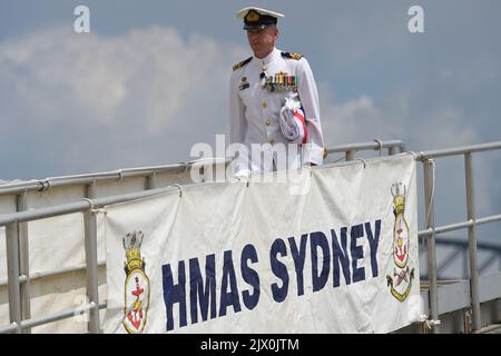 Commanding Officer Lieutenant Commander David Murphy salutes to the ...