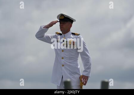 Commanding Officer Lieutenant Commander David Murphy salutes to the ...