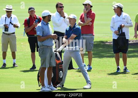 Jordan Spieth, front, and his caddie Michael Greller line up a putt ...