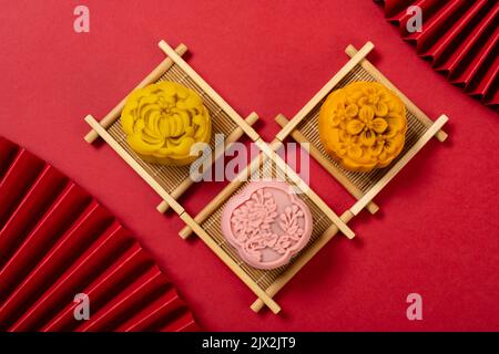 trendy flower shape mooncake on red background with copy space Stock ...