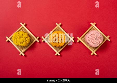 trendy flower shape mooncake on red background Stock Photo - Alamy