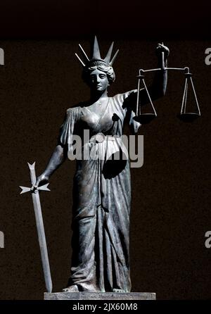 The statue of justice Themis or Iustitia, the blindfolded goddess of ...