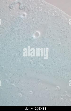 Cream liquid gel serum flows down red silver texture, makeup and ...