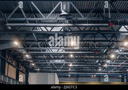 Ceiling of large factory building with artificial lighting. Industrial ...