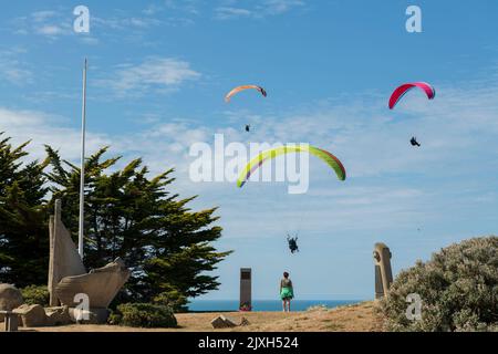 Paragliding flight over the beach on the cliffs Stock Photo - Alamy