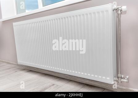 Modern radiator under window at home. Central heating system Stock ...