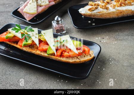 Traditional Spanish breakfast. Tostada with different toppings on a ...