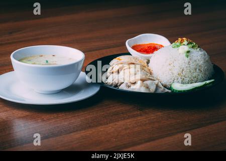 Chicken served with rice, vegetable salad, and a bowl of soup Stock ...