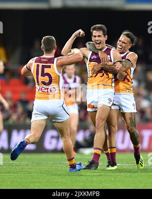 Brandon Starcevich (centre) of the Lions celebrates kicking his first ...