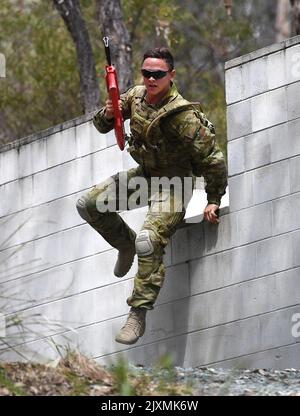 Soldiers from Australia's 7th Combat Brigade carry a US marine playing ...