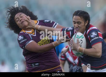 Tazmin Gray of the Roosters fends off a tackle from Teuila Fotu-Moala ...
