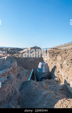 An culvert or ditch being constructed or dug in an active solid-waste ...