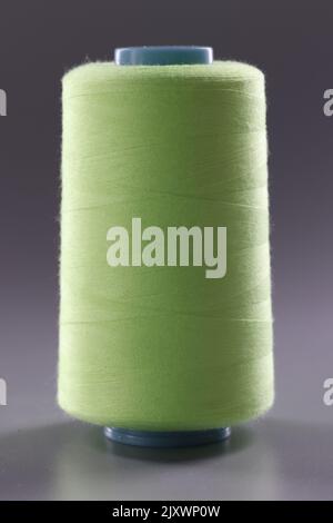 Spool of light grey sewing thread isolated on white Stock Photo - Alamy
