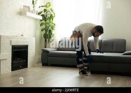 Man assembling sofa furniture at home Stock Photo - Alamy