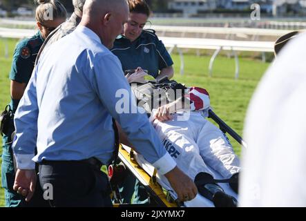 Jockey Clayton Gallagher is taken away by paramedics after he was ...