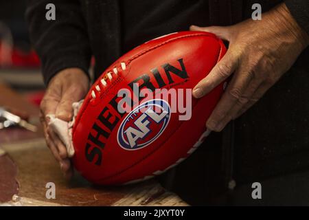 Staff work on the production of Sherrin footballs to be used in the ...