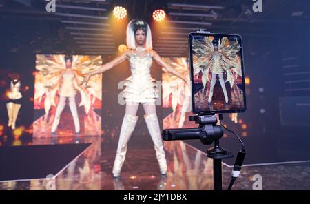 EDITORIAL USE ONLY Drag queen Tia Kofi wearing a dress designed by Sal ...