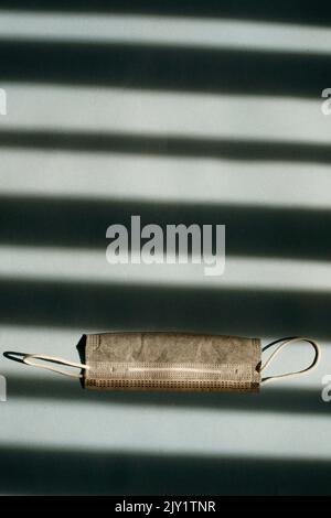 Closeup shot of a light blue protection mask on a white t Stock Photo ...