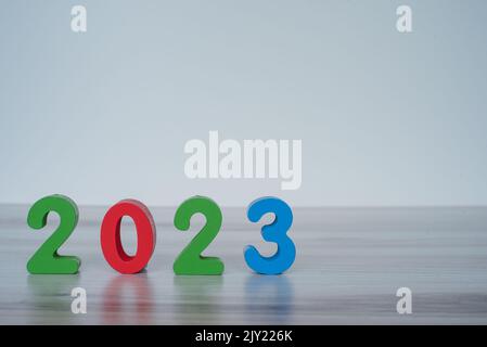 2023 standing colored block numbers on light wooden and white ...