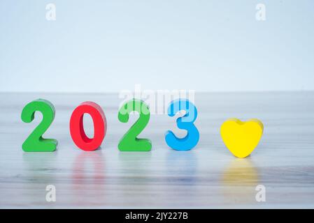 2023 standing colored block numbers on light wooden and white ...