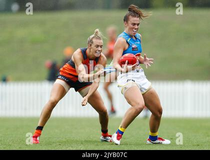Jamie Stanton of the Suns competes with Elle Bennetts of the Giants ...