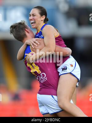 Dakota Davidson (left) of the Lions celebrates kicking a goal with team ...