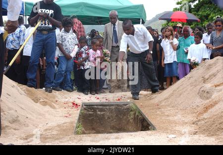 Palm Island, December 11, 2004. Palm Islanders walk with the hearse ...