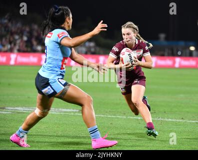 Tarryn Aiken (right) of the Maroons heads for the try line to score a ...