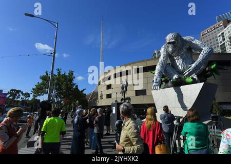People observe a large-scale sculpture of chimpanzee David Greybeard ...