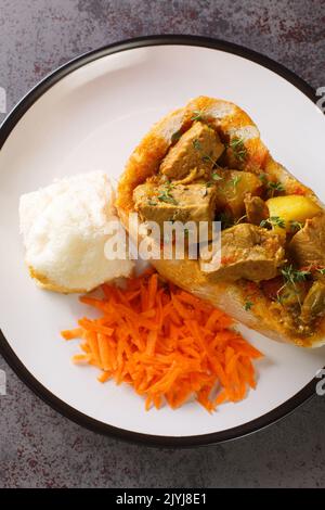 traditional durban mutton bunny chow closeup on plate on the table ...